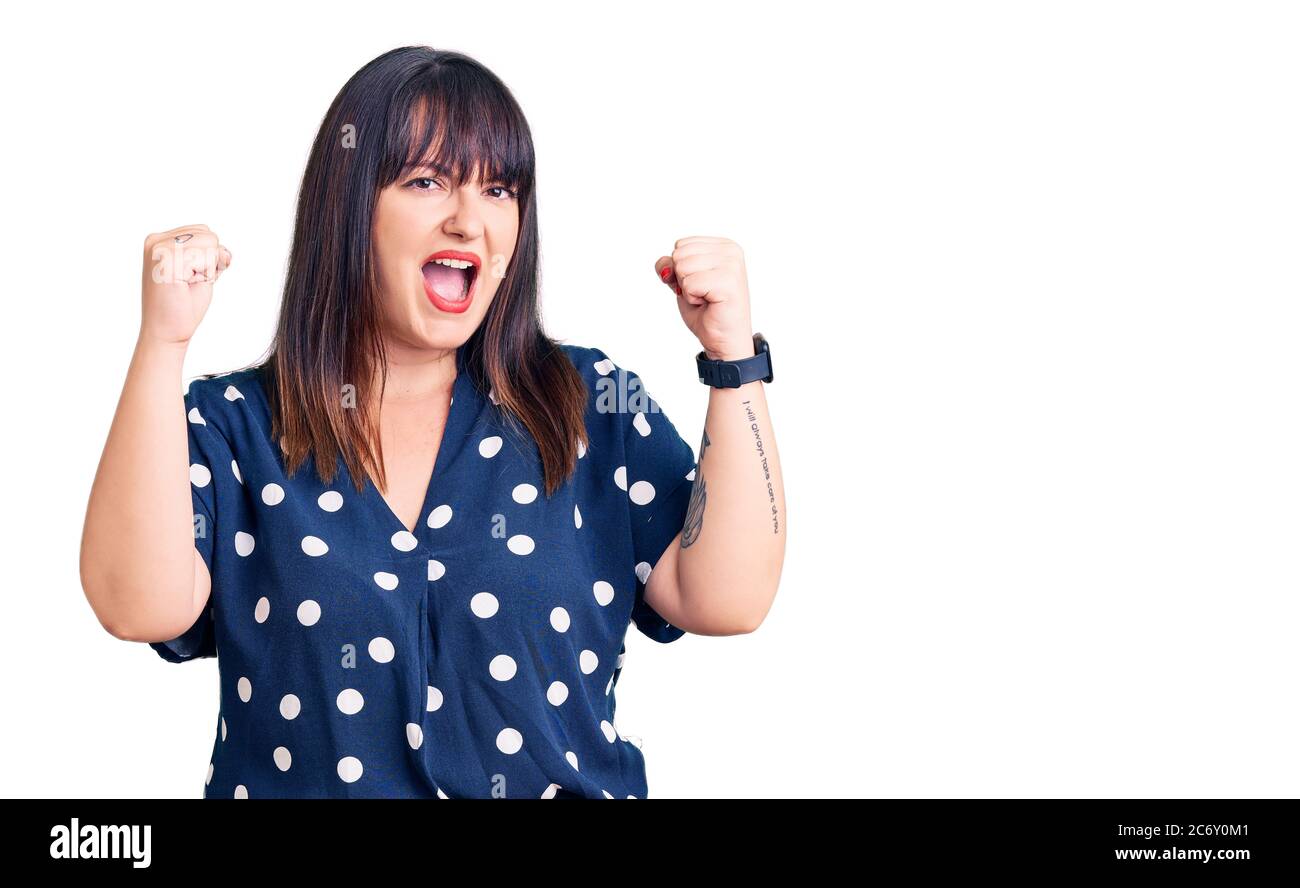Young plus size woman wearing casual clothes angry and mad raising ...