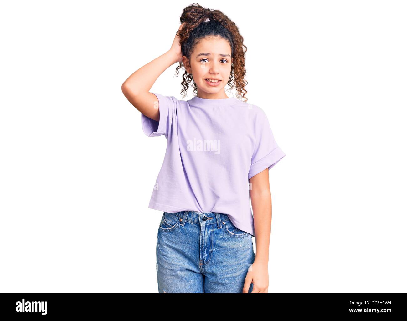 Beautiful kid girl with curly hair wearing casual clothes confuse and ...