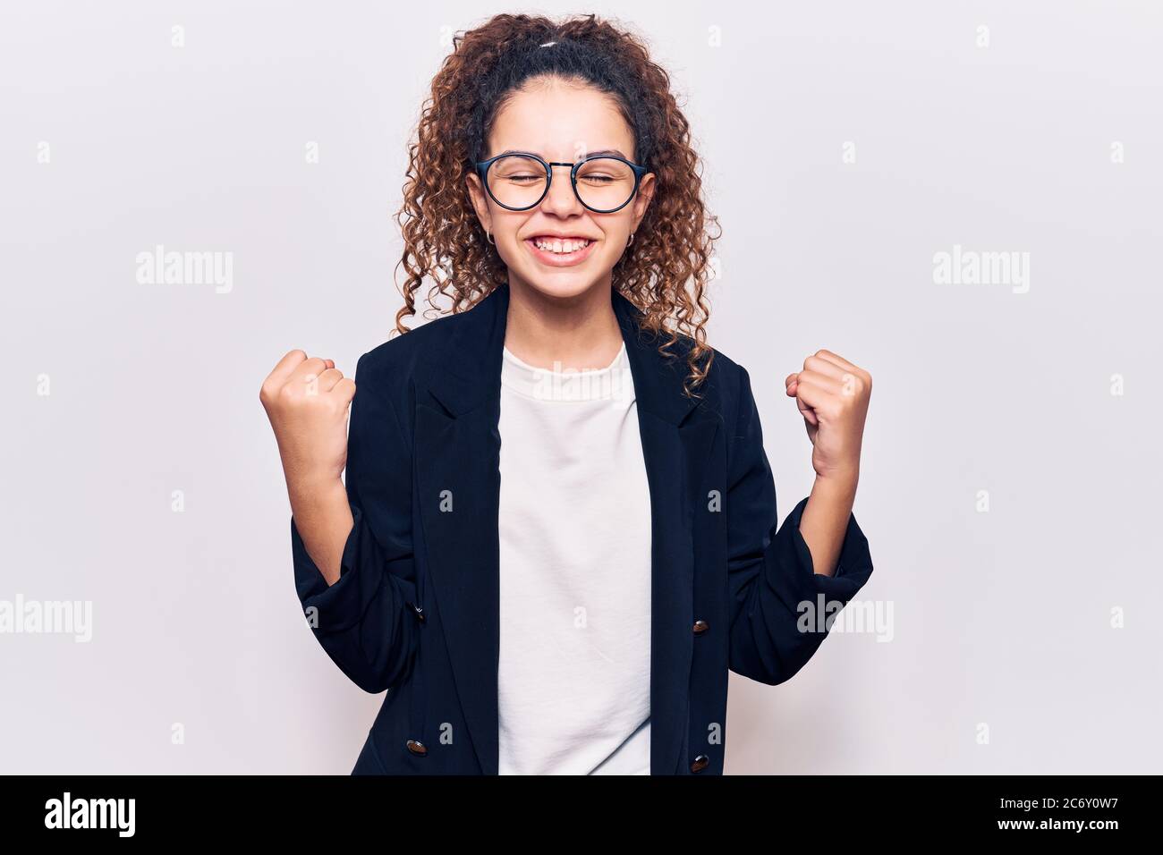 Beautiful kid girl with curly hair wearing business clothes and glasses ...