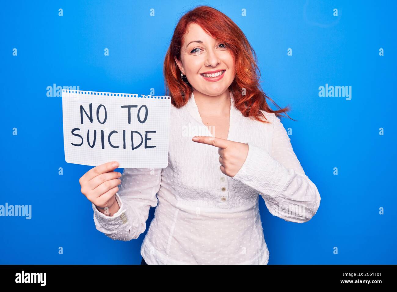 Young redhead woman asking for stop depression holding paper with not ...