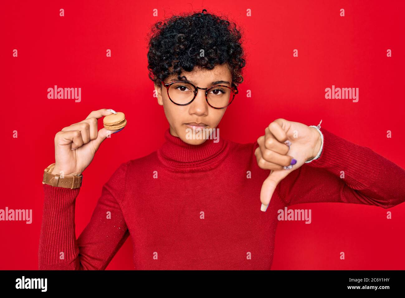 Young beautiful african american afro woman holding chocolate french ...