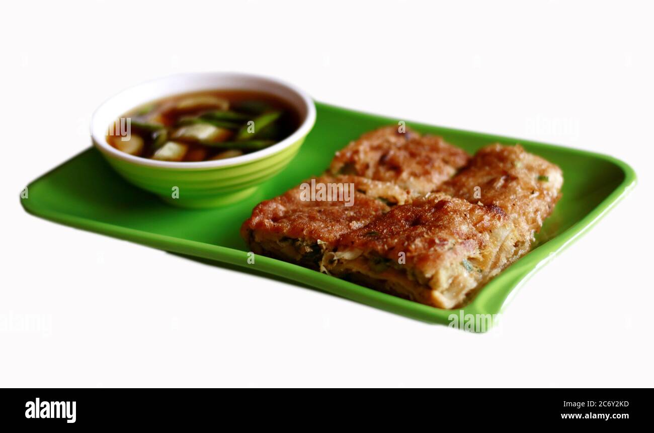Martabak Telur. A square crepes filled with mixture of egg, green onion ...