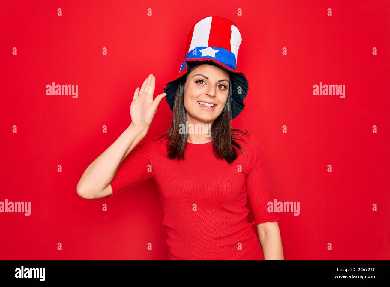 Young beautiful brunette woman wearing united states hat celebrating ...