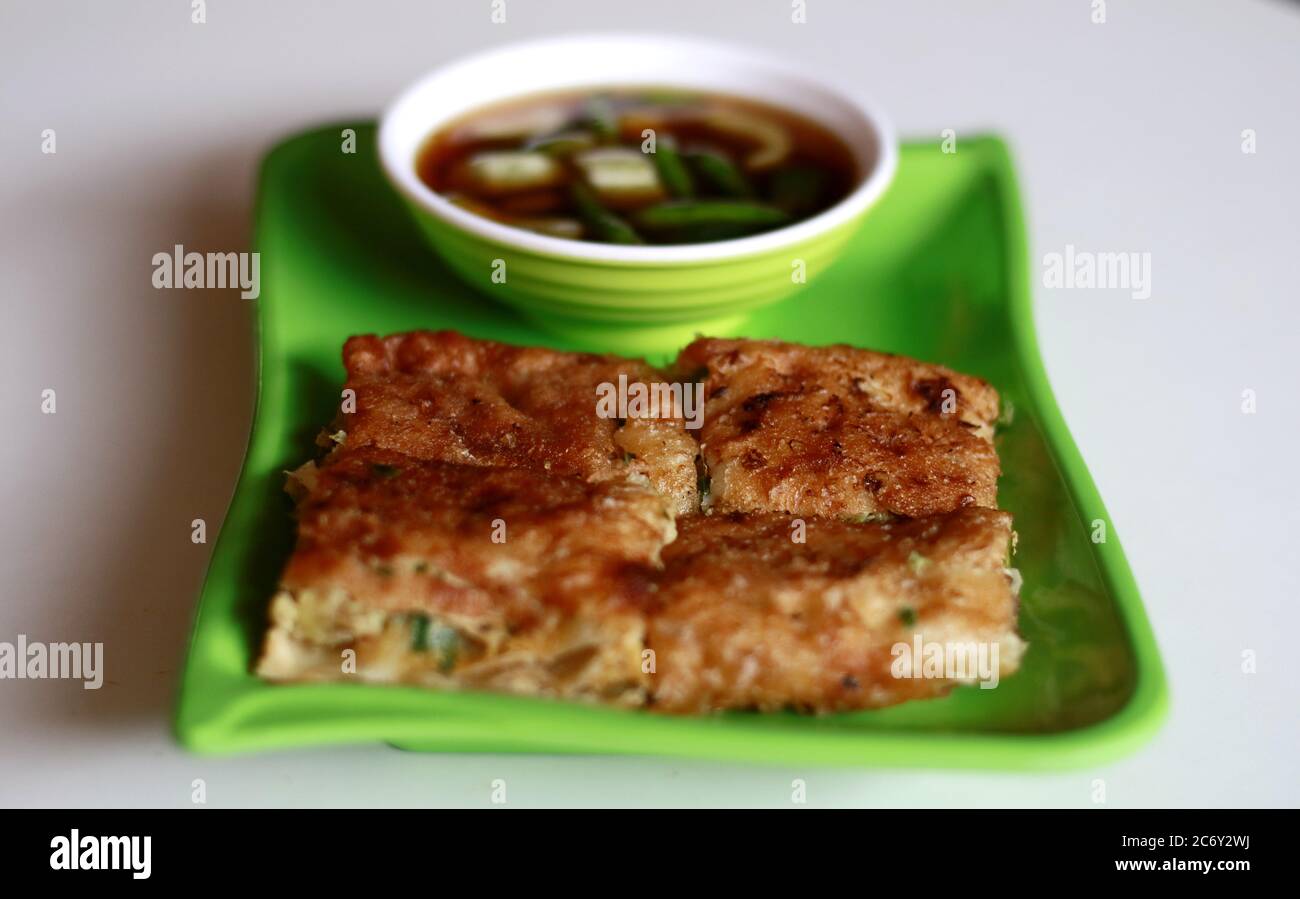 Martabak Telur. A square crepes filled with mixture of egg, green onion ...