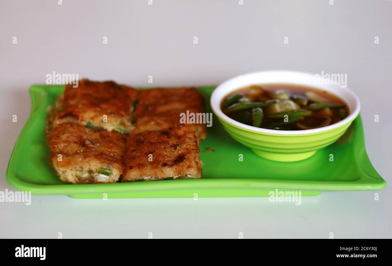 Martabak Telur. A square crepes filled with mixture of egg, green onion ...