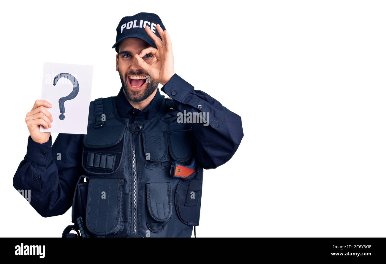 Young handsome man with beard wearing police uniform holding question ...