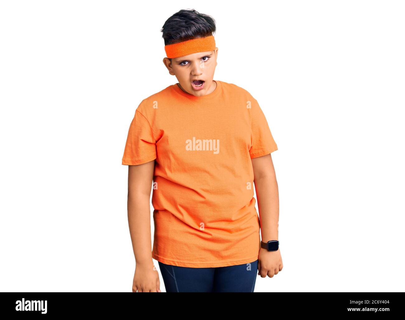 Little boy kid wearing sportswear in shock face, looking skeptical and ...