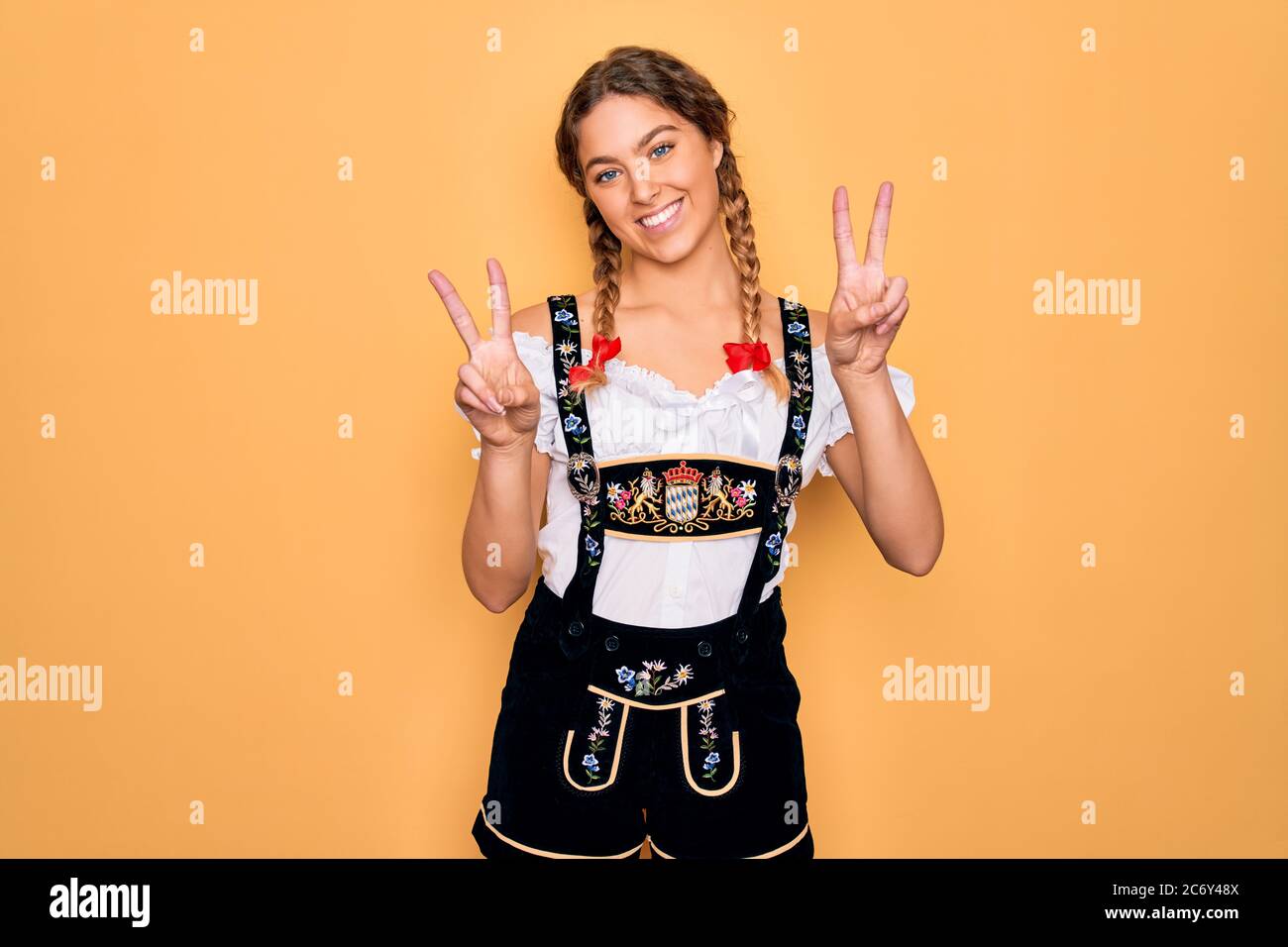 Young beautiful blonde german woman with blue eyes wearing traditional ...