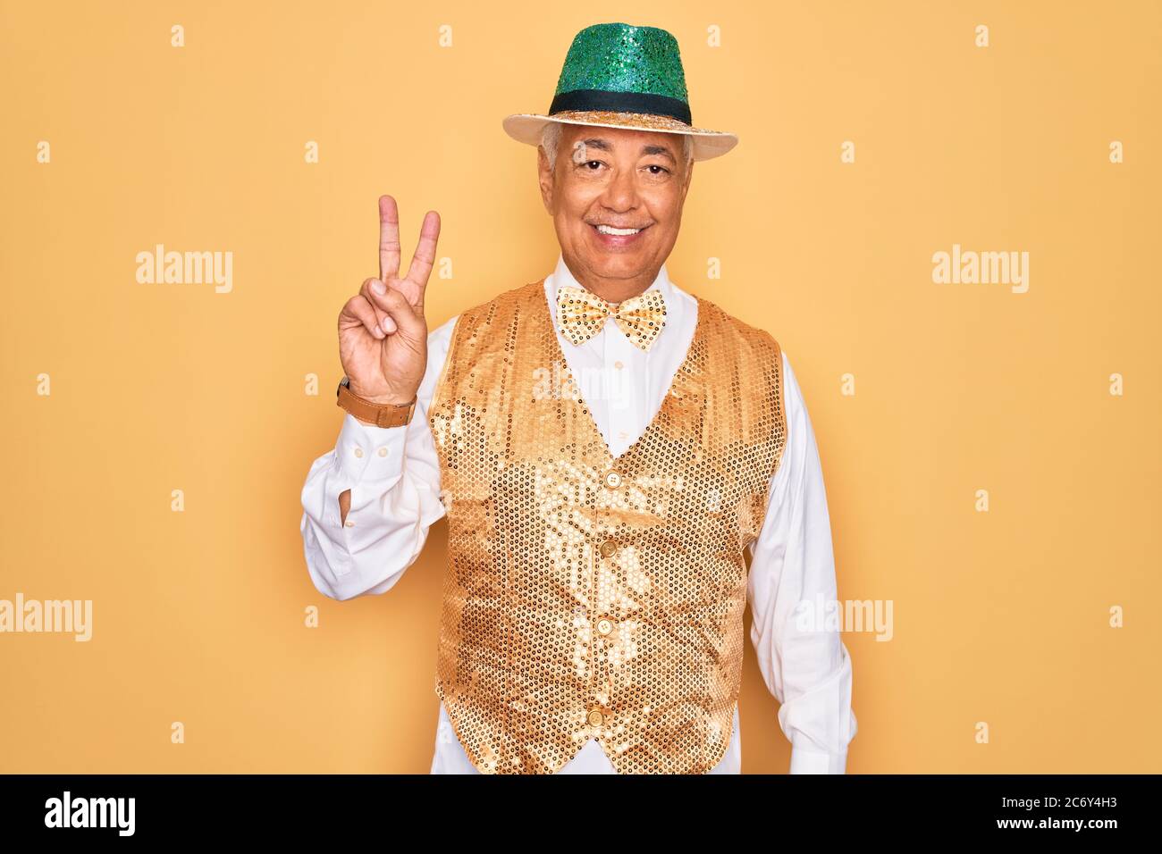 Middle age senior grey-haired man wearing Brazilian carnival custome ...