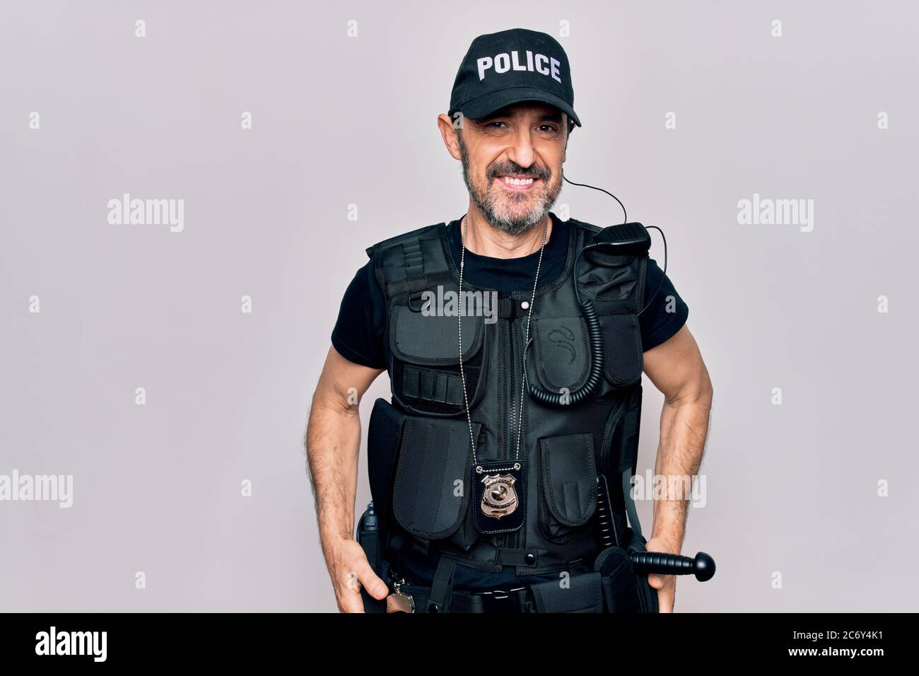 Middle age policeman wearing police uniform and bulletproof vest over ...