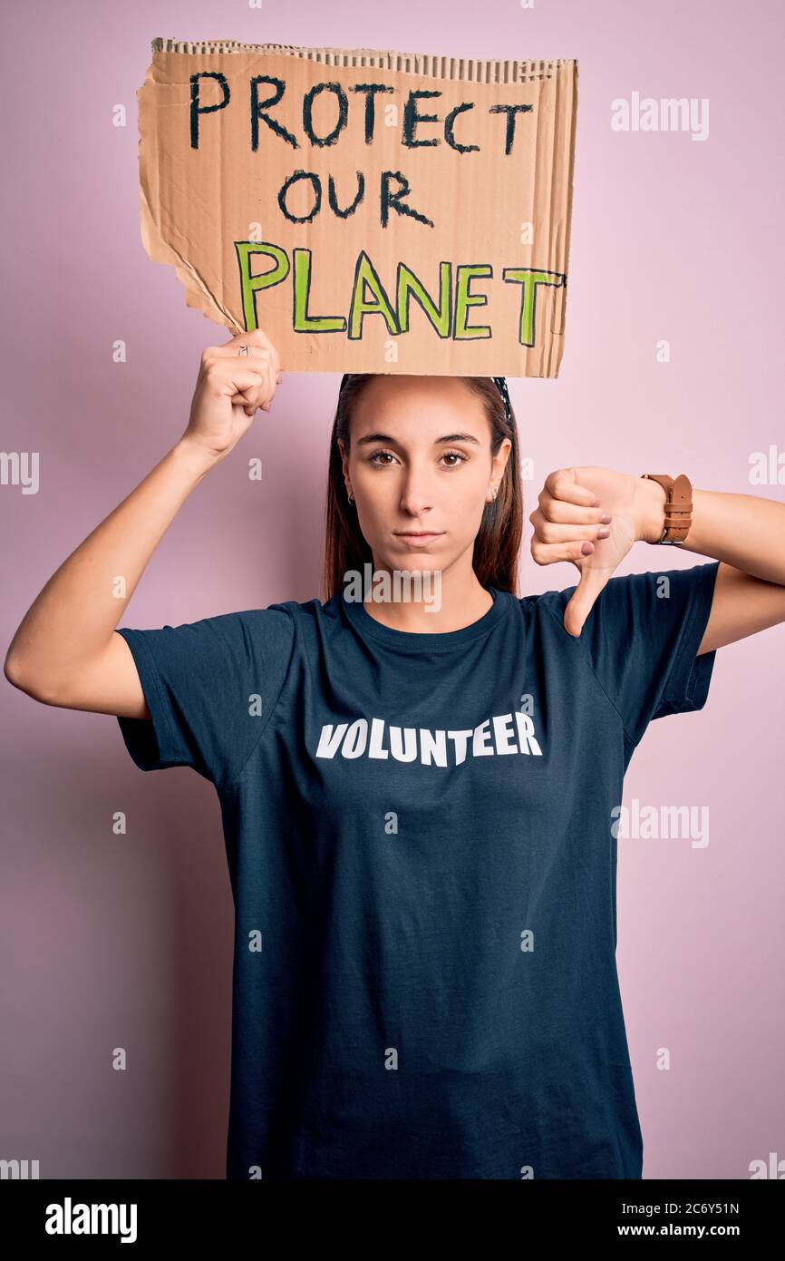 Beautiful volunteer woman doing volunteering holding banner with ...