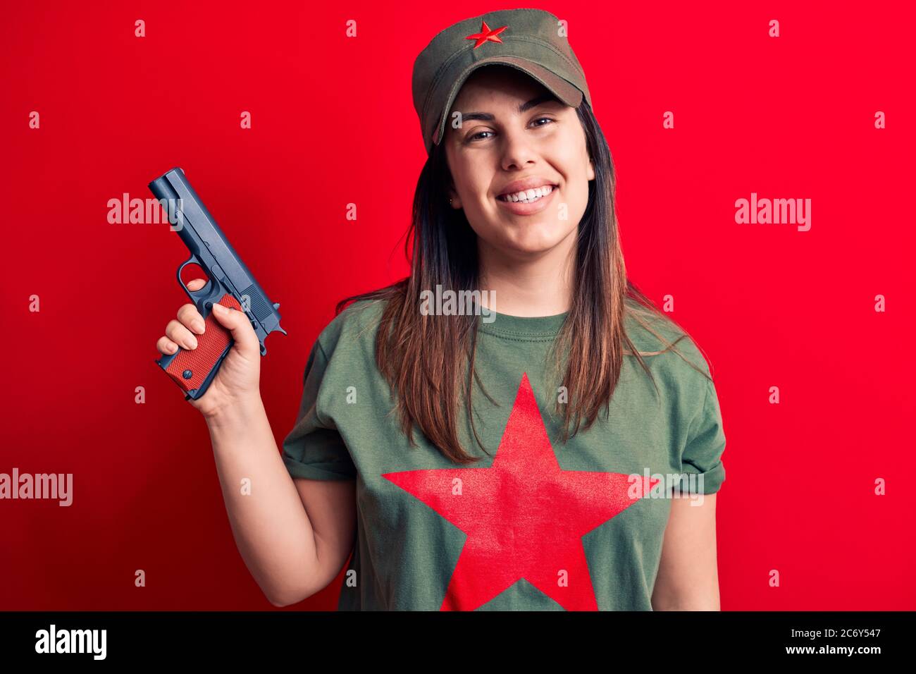 Young beautiful brunette woman wearing t-shirt with red star communist ...