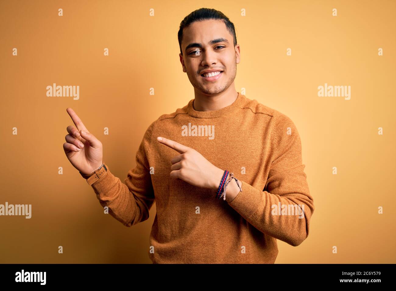 Young brazilian man wearing casual sweater standing over isolated ...