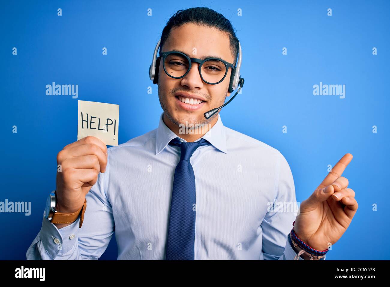 Young brazilian call center agent man overworked holding reminder paper ...