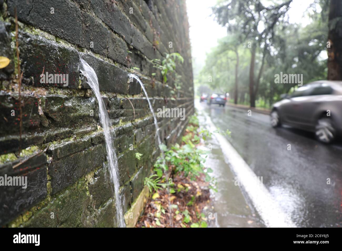Due to the enduring downpour, 600-year-old ancient city wall drains off ...