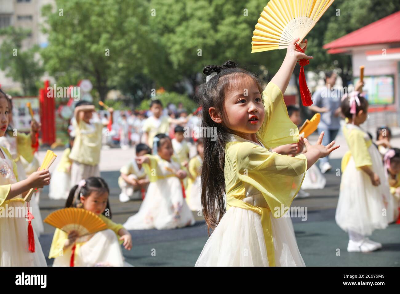 Dressed in ancient Chinese clothes, children at a local kindergarten ...