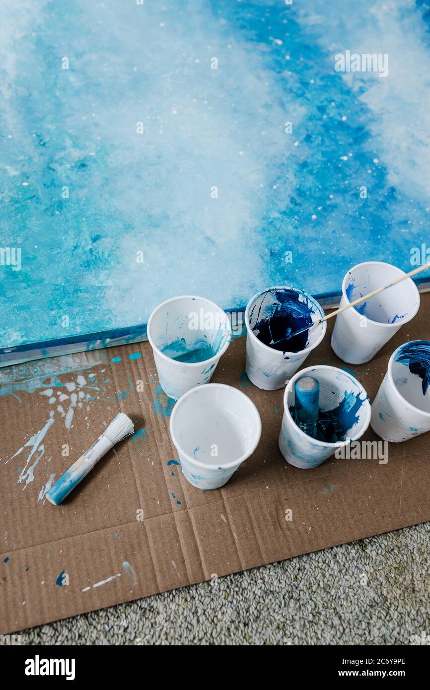arts and craft hobbies concept, blue and white acrylic painting with ...
