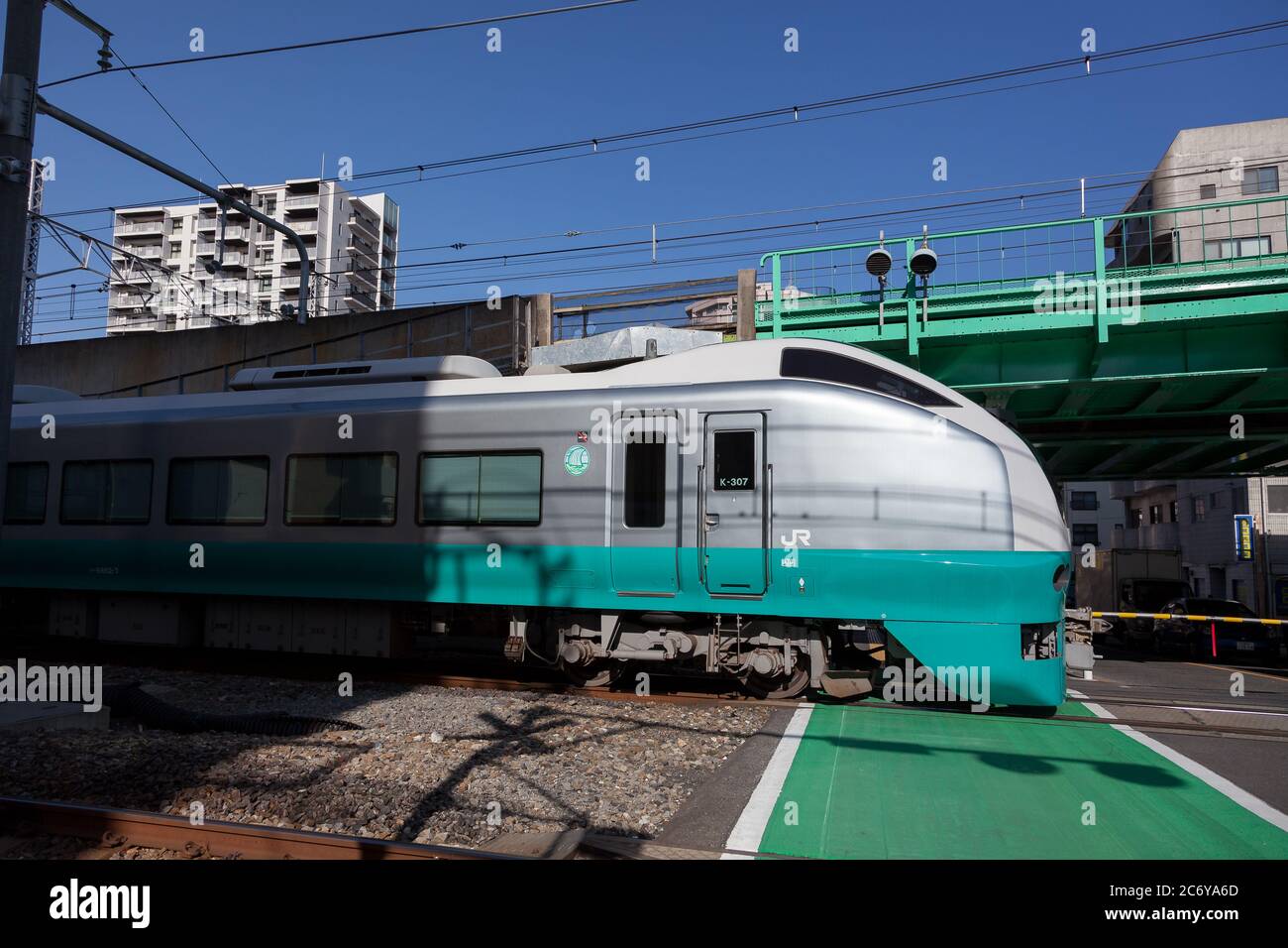 An E-653 (Fresh Hitachi K307)) series train in colourful livery passes ...