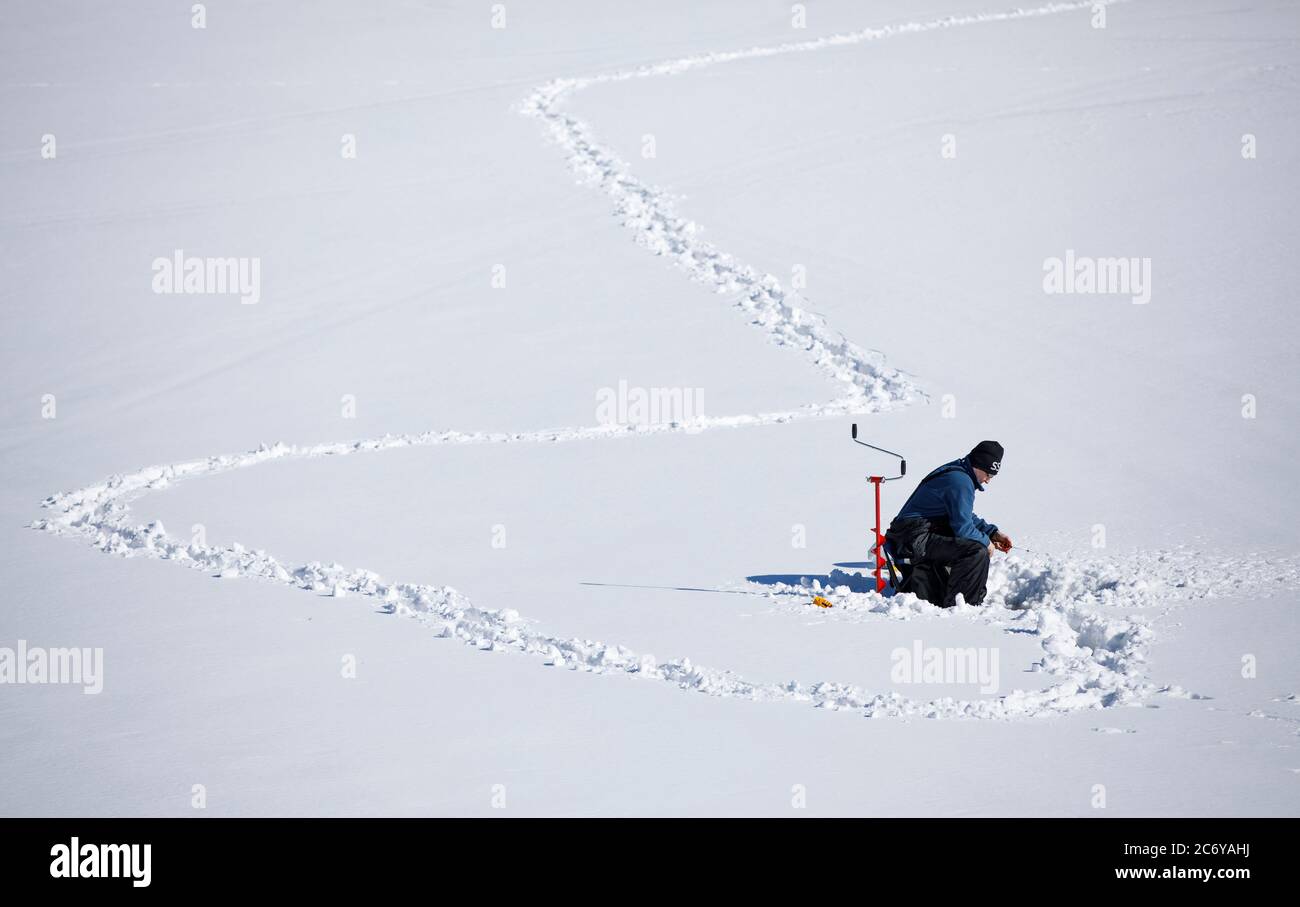 A middle-aged man ice fishing at Winter , Finland Stock Photo - Alamy