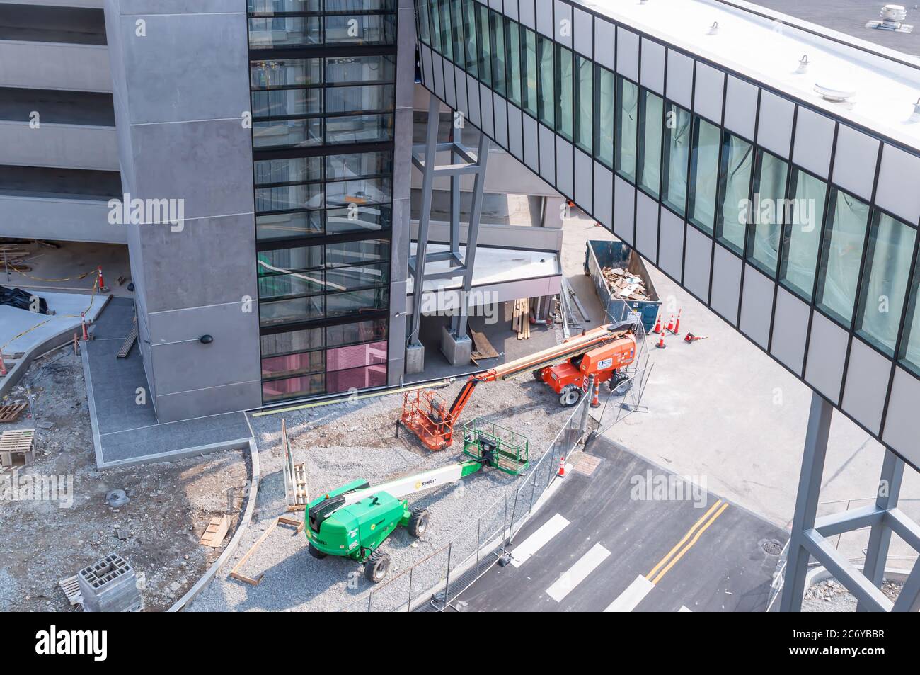 A construction site under an elevated walkway into a parking garage ...