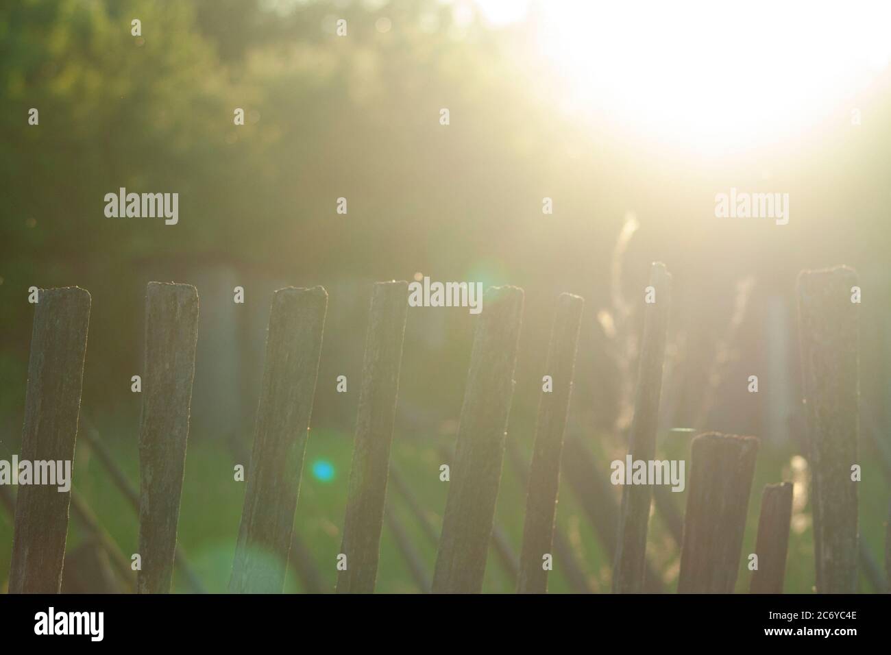 the old wooden fence from behind shines Stock Photo - Alamy