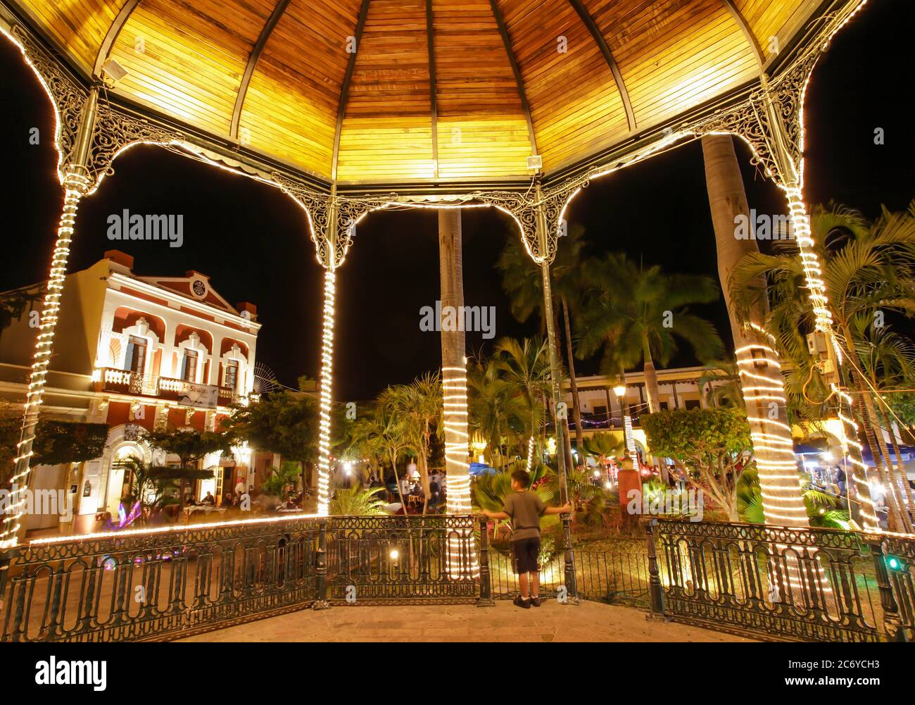 Boy looks out on the Plaza Machado from inside its kiosko in Mazatlan ...