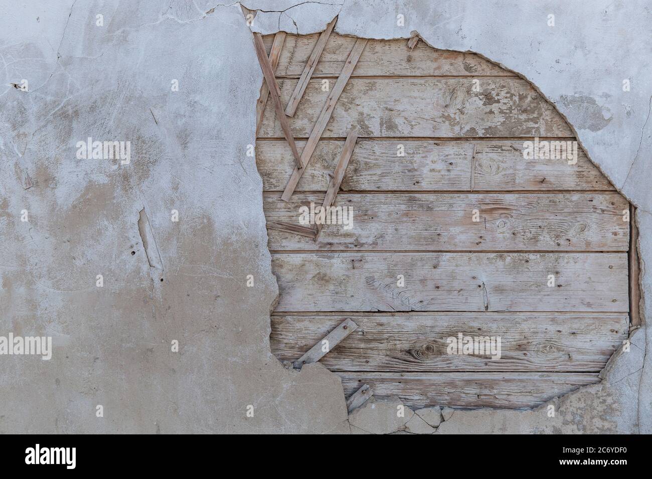 The old wall that is crumbling. You can see the wooden boards from ...