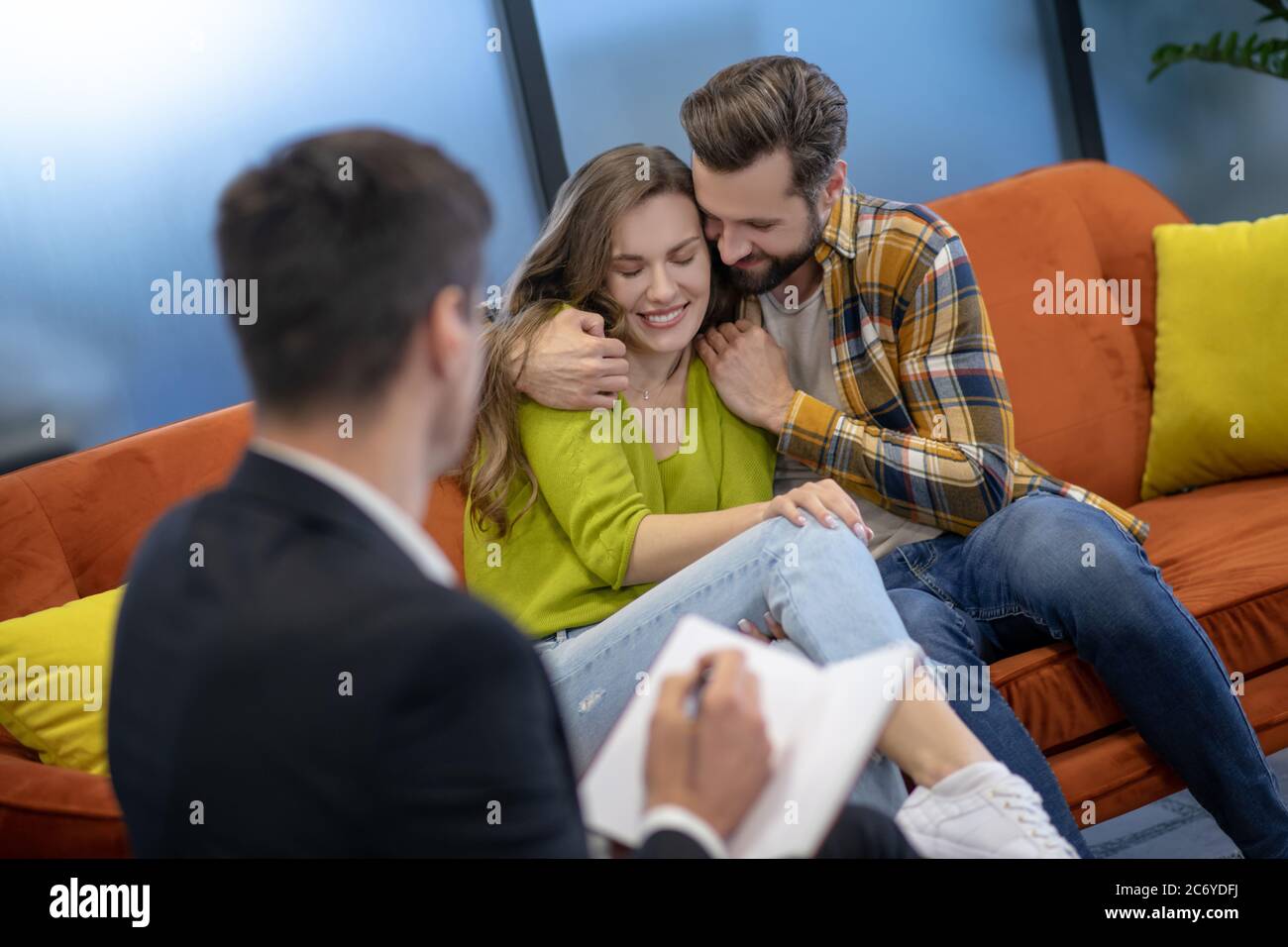Happy couple having a session with family relationships coach Stock ...
