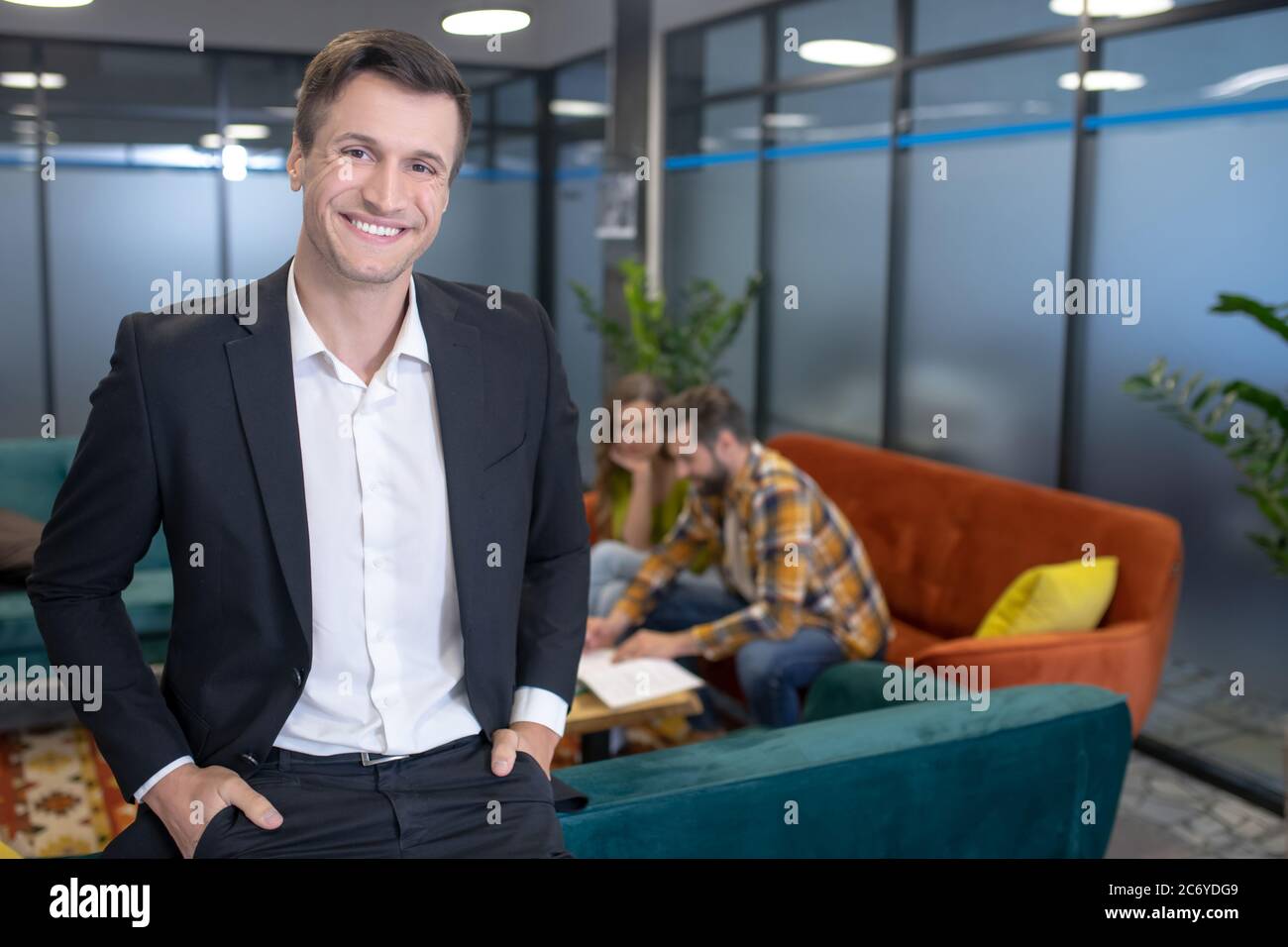 Handsome young man wearing an official suite Stock Photo - Alamy