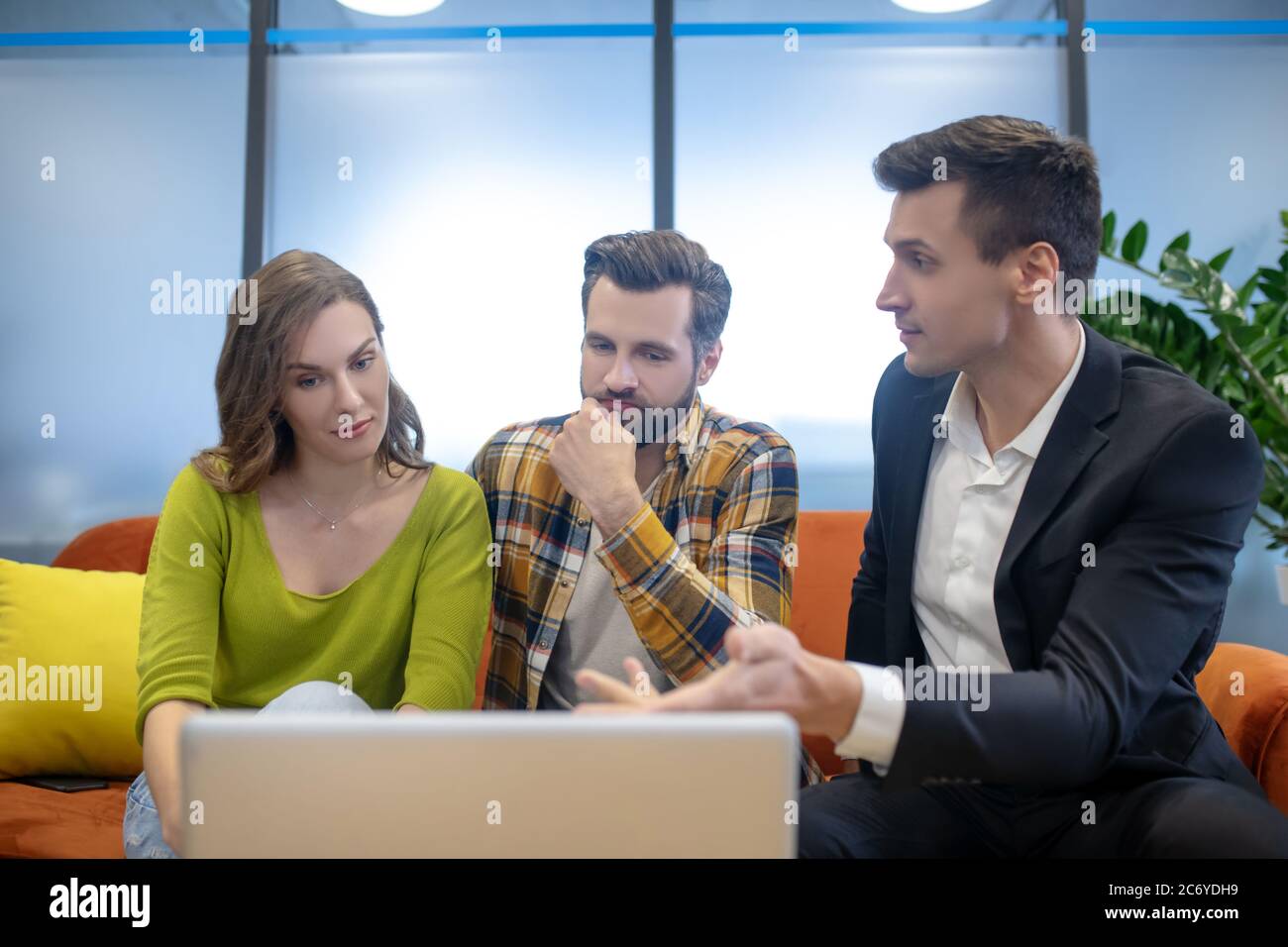 Sales agent showing a project to his clients Stock Photo - Alamy