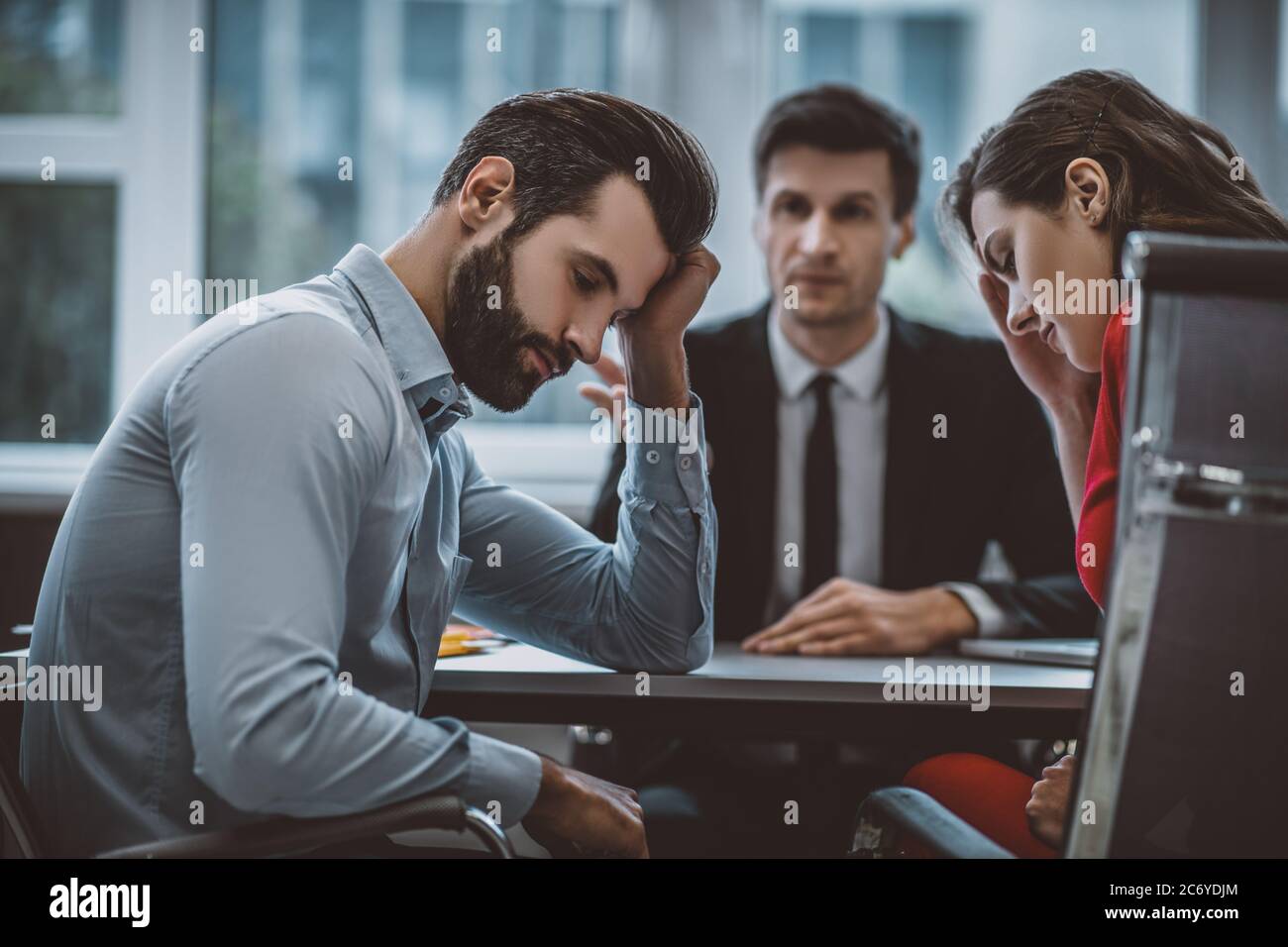 Two employees feeling ashamed in front of their boss Stock Photo - Alamy