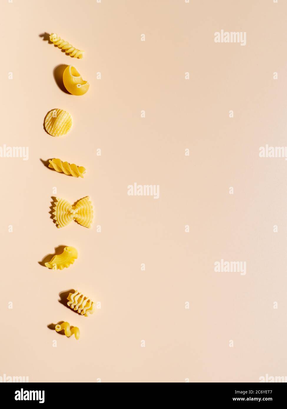 Pasta art. Different types of pasta on cream pastel background in hard ...