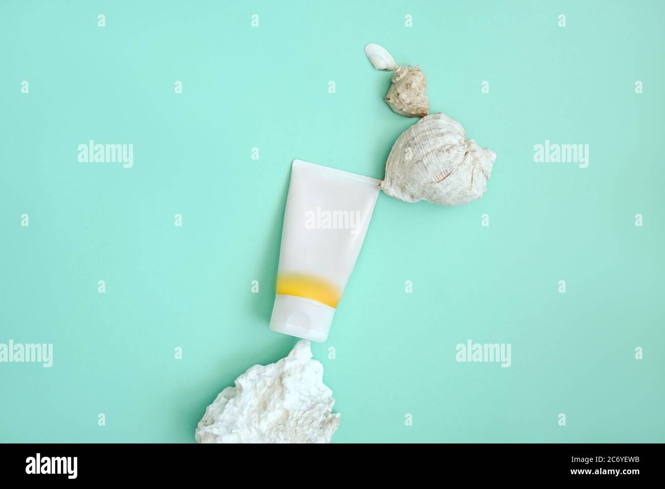 Sunscreen in the middle of natural composition from shells, stone. Flat ...