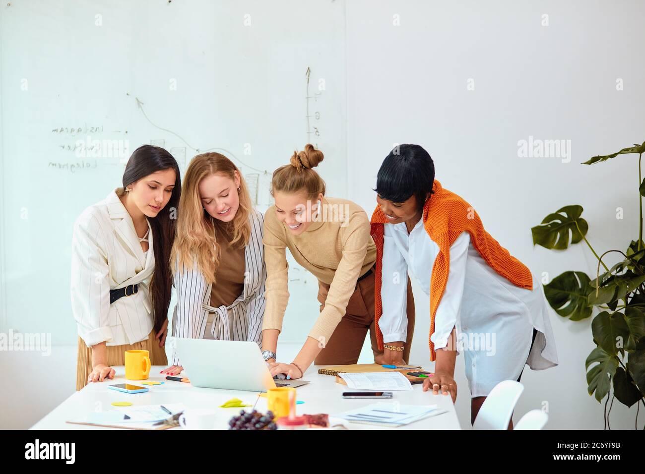 Caucasian and african women, business ladies gathered in modern white ...