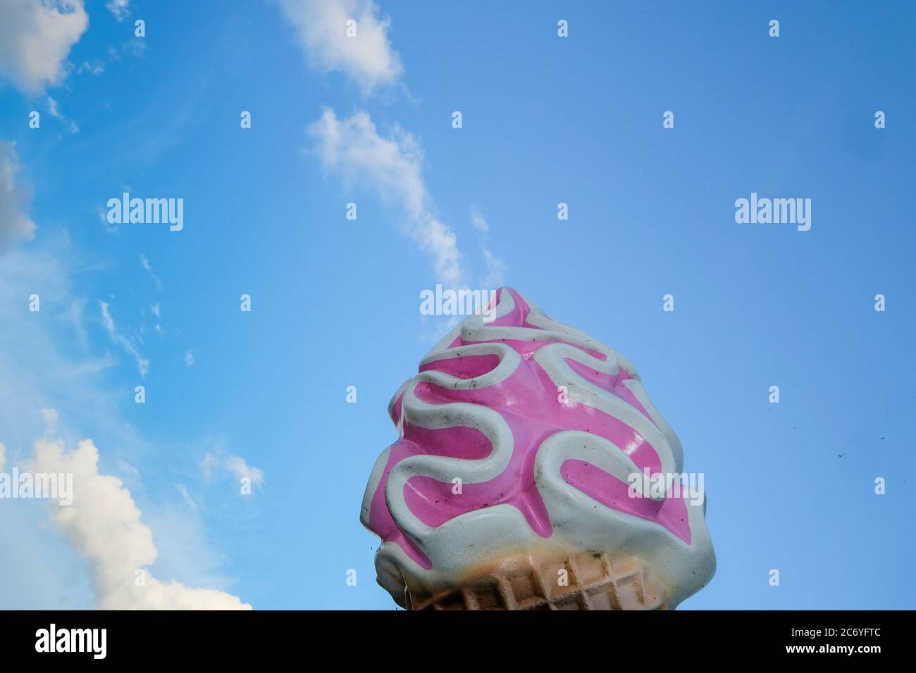 A giant, plastic, pink, soft-serve ice cream cone sculpture. In NIda ...