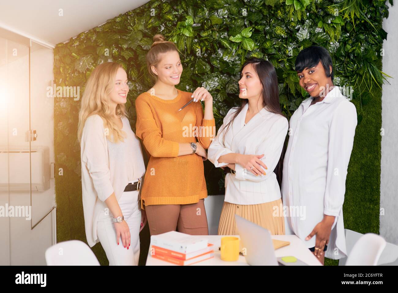 successful teamwork of enthusiastic women coworking together in modern ...