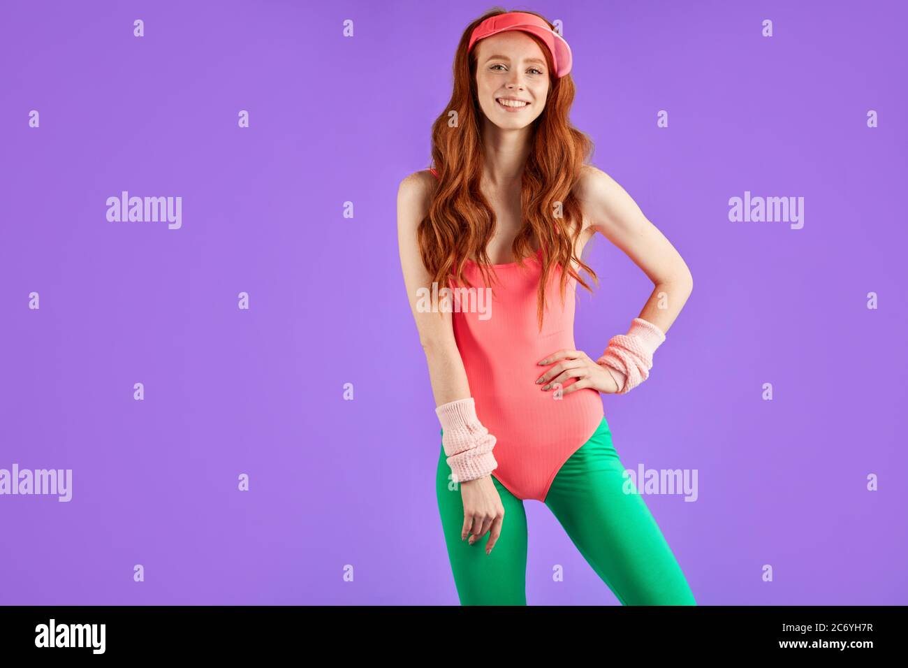 Sporty appealing ginger girl modeling and posing at camera for fitness ...