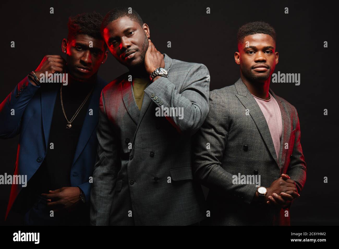 Group of three african friends dressed in stylish suits posing isolated ...