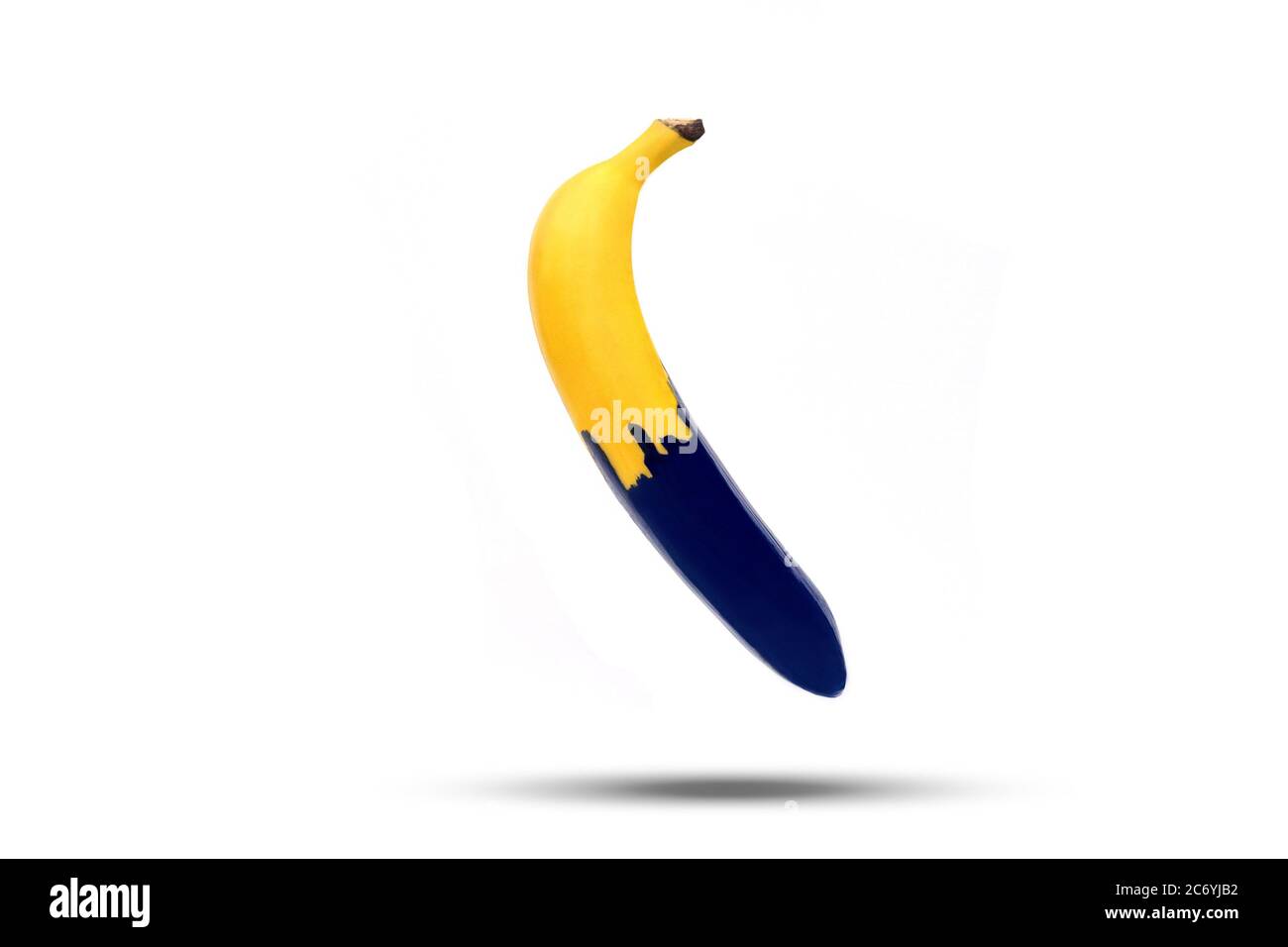 Weightless banana on white background. Banana bottom painted blue ...