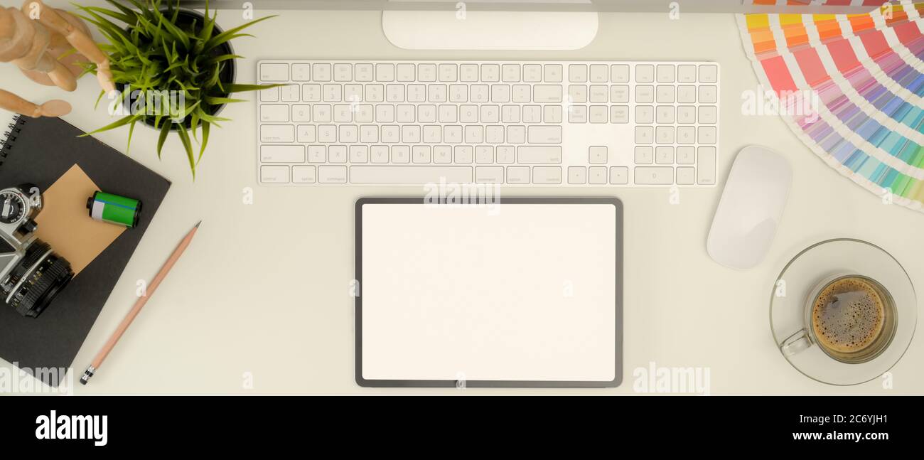 Top view of mock up digital tablet on office desk with computer device ...