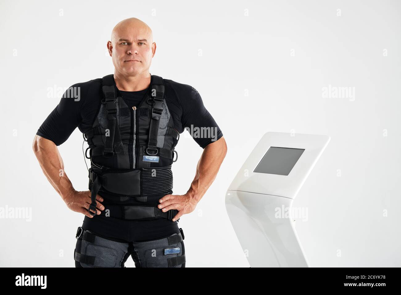 awesome muscular man testing EMS device. isolated white background ...