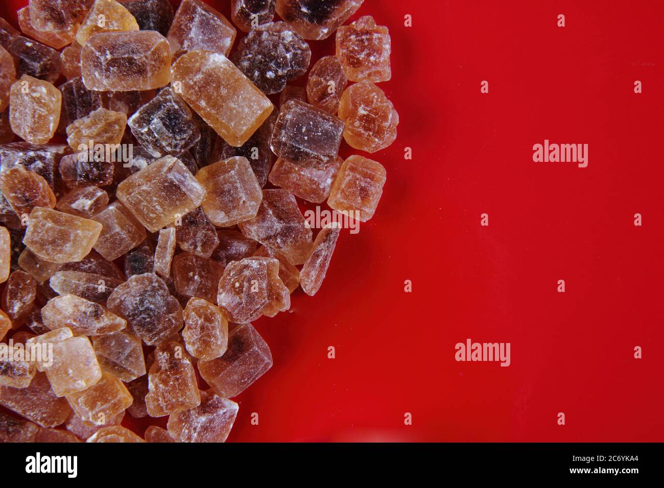 dark sugar on the red as food background Stock Photo - Alamy