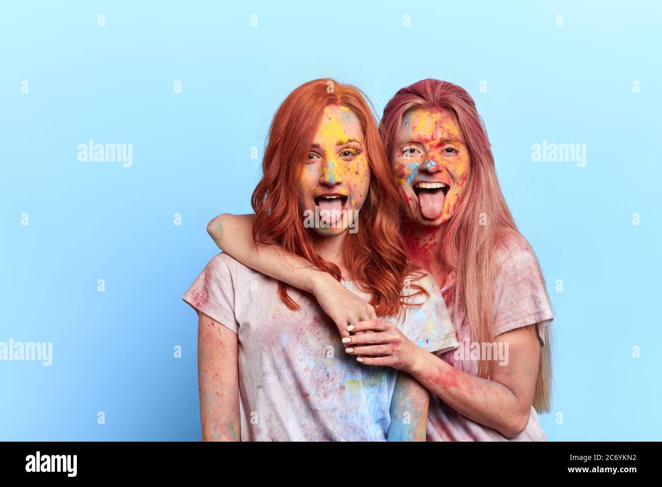 two crazy best friends hugging and sticking their tongues out at the ...