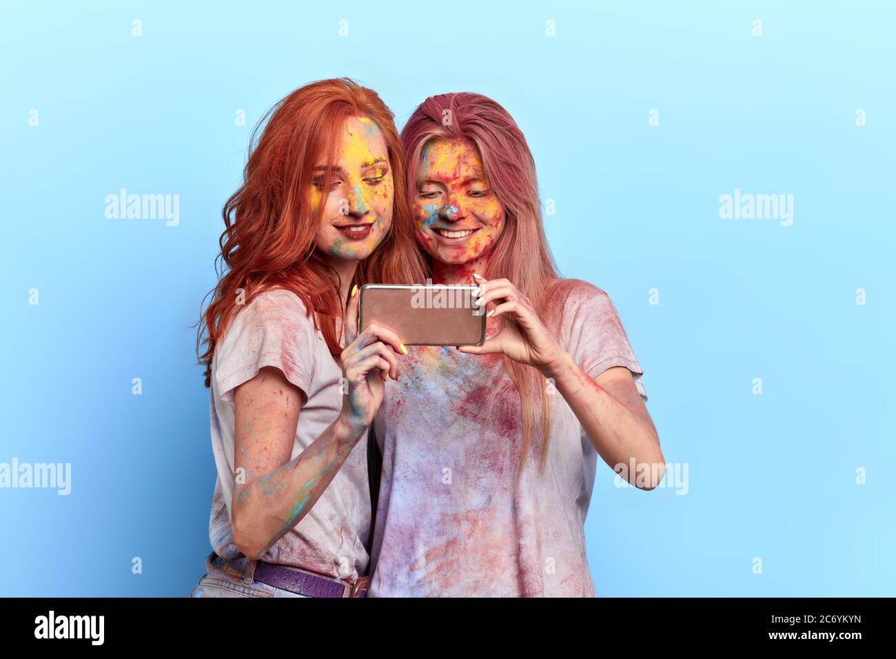 Cheerful Positive Sisters With Colourful Faces Taking A Picture On The