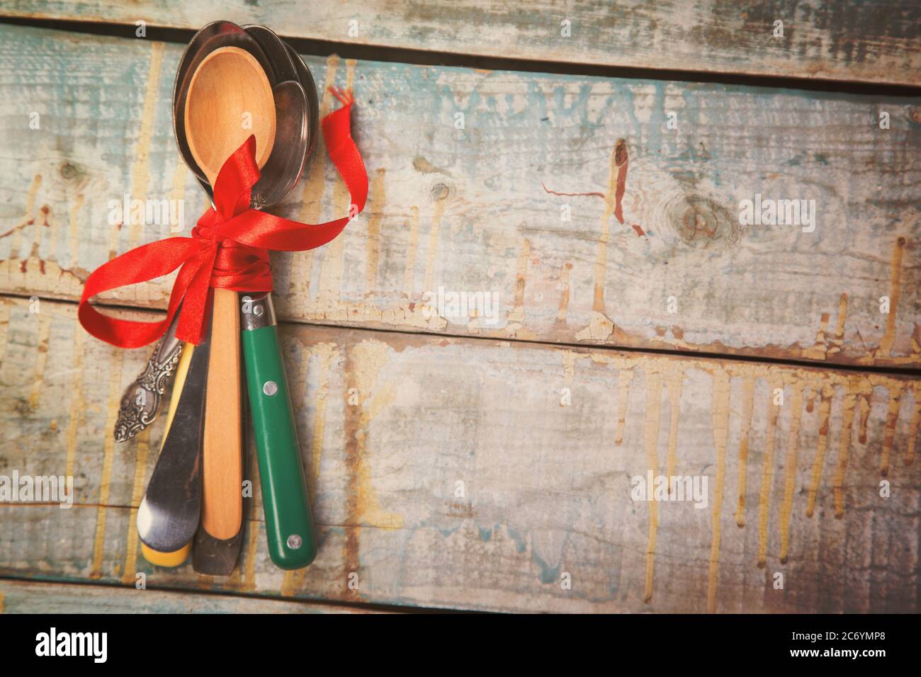 metallic and wooden retro spoons,in red ribbon Stock Photo - Alamy