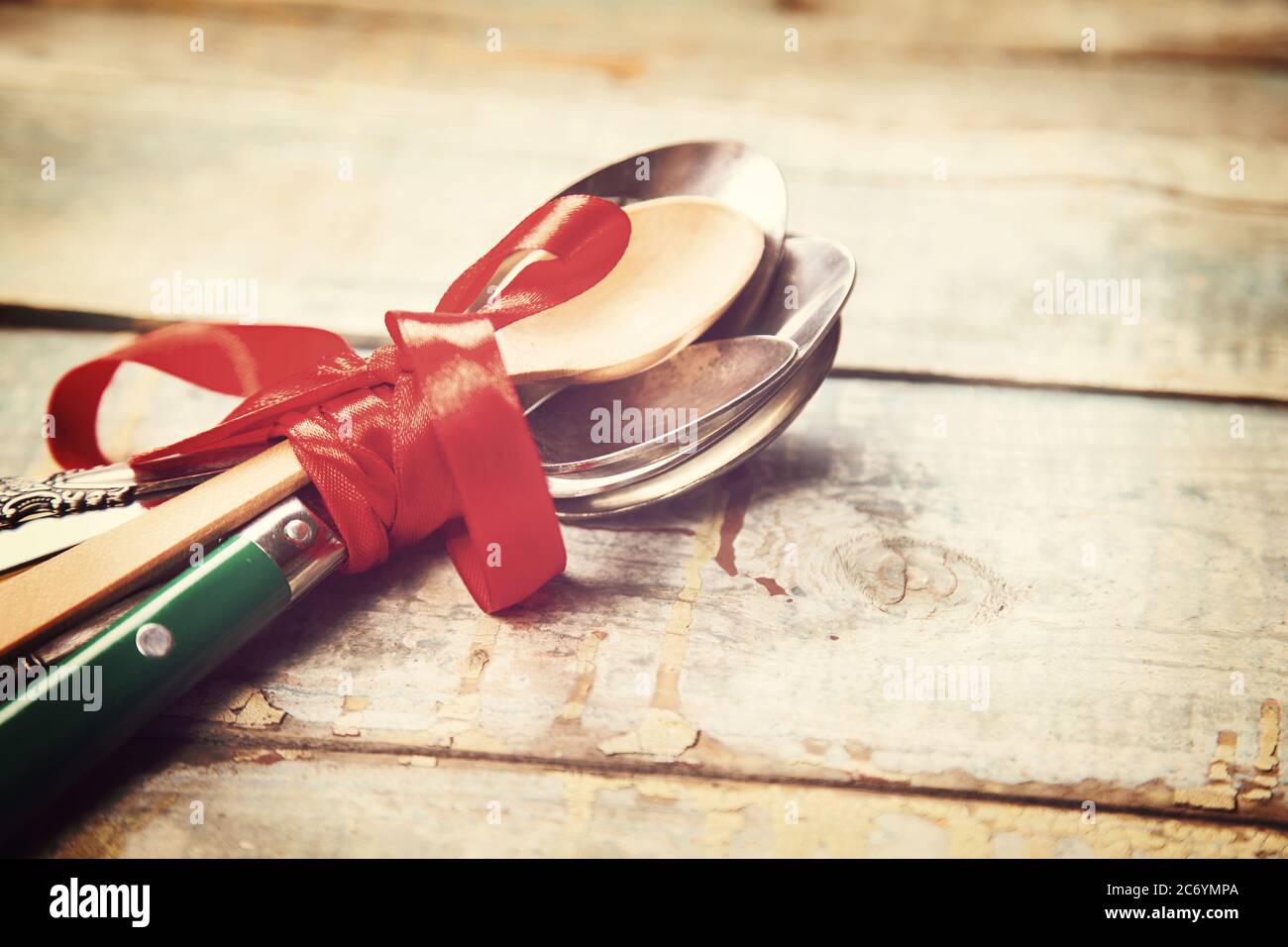 metallic and wooden retro spoons,in red ribbon Stock Photo - Alamy