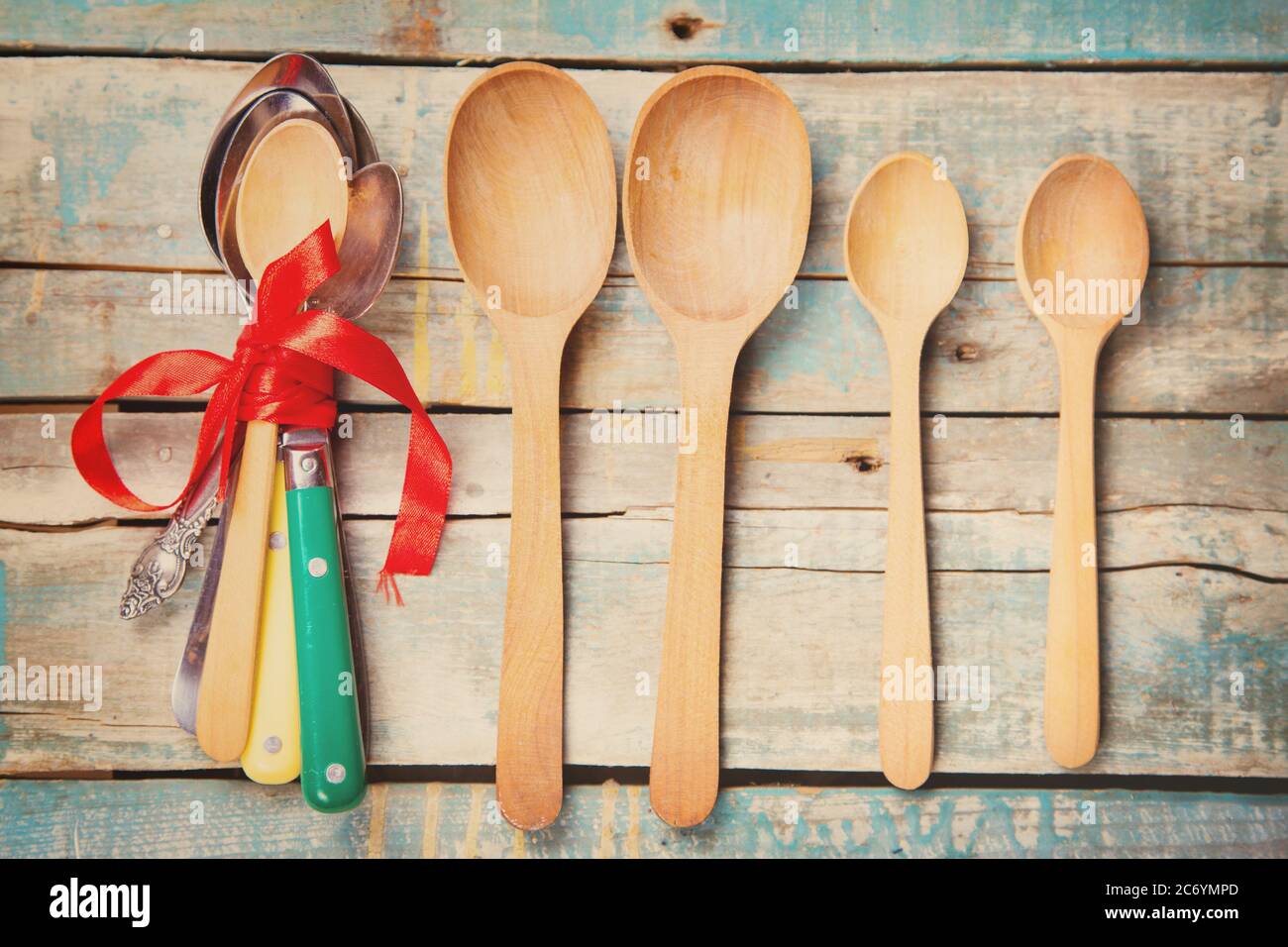 metallic and wooden retro spoons,in red ribbon Stock Photo - Alamy