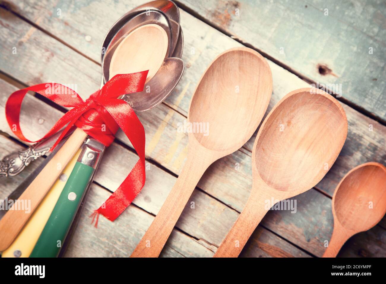 metallic and wooden retro spoons,in red ribbon Stock Photo - Alamy