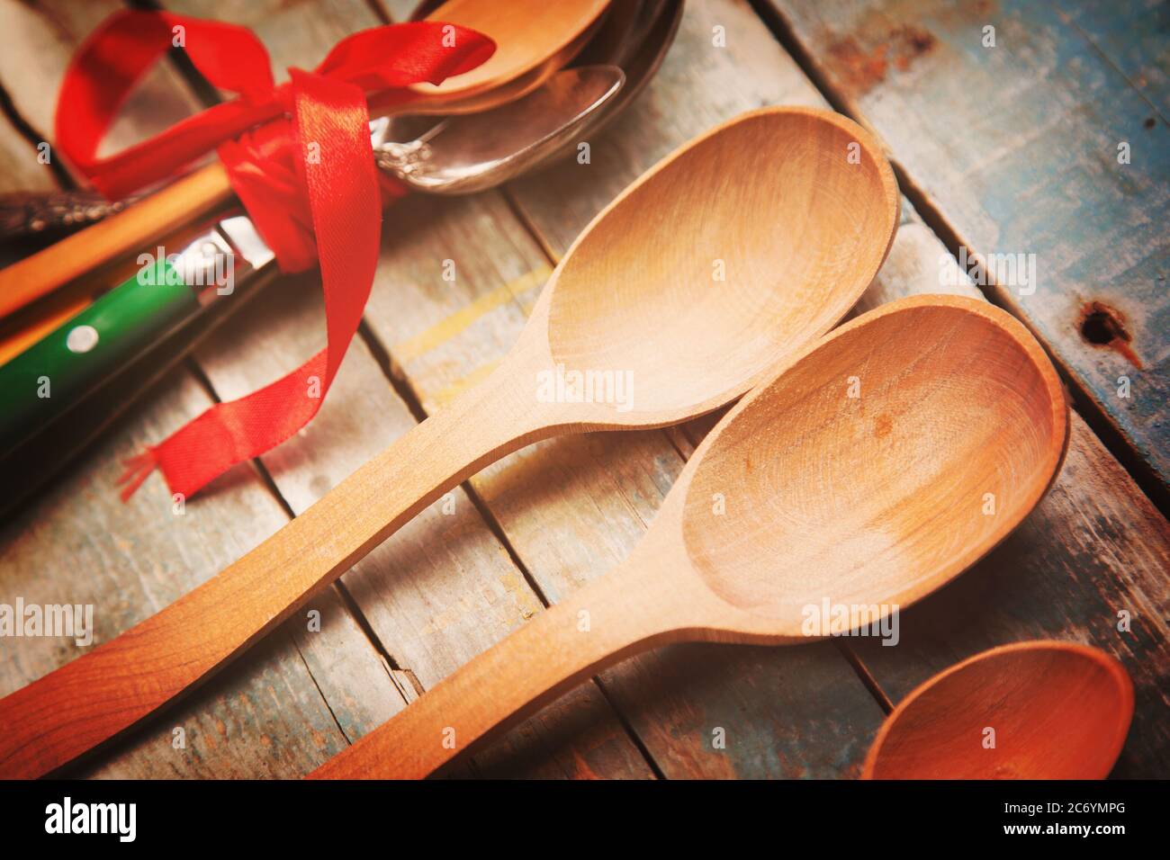 metallic and wooden retro spoons,in red ribbon Stock Photo - Alamy