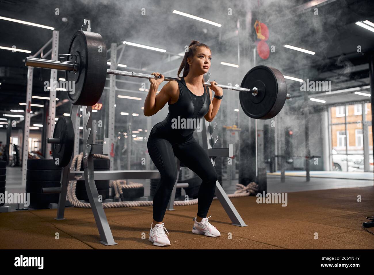 Charming beautiful female weightlifter training in modern fitness ...